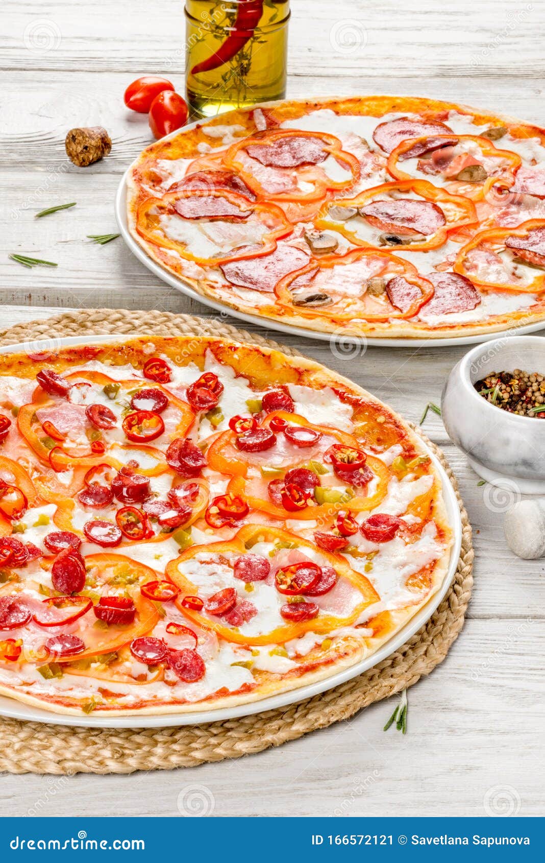 Two Pizzas on a White Wooden Background Shot Vertically Stock Image ...