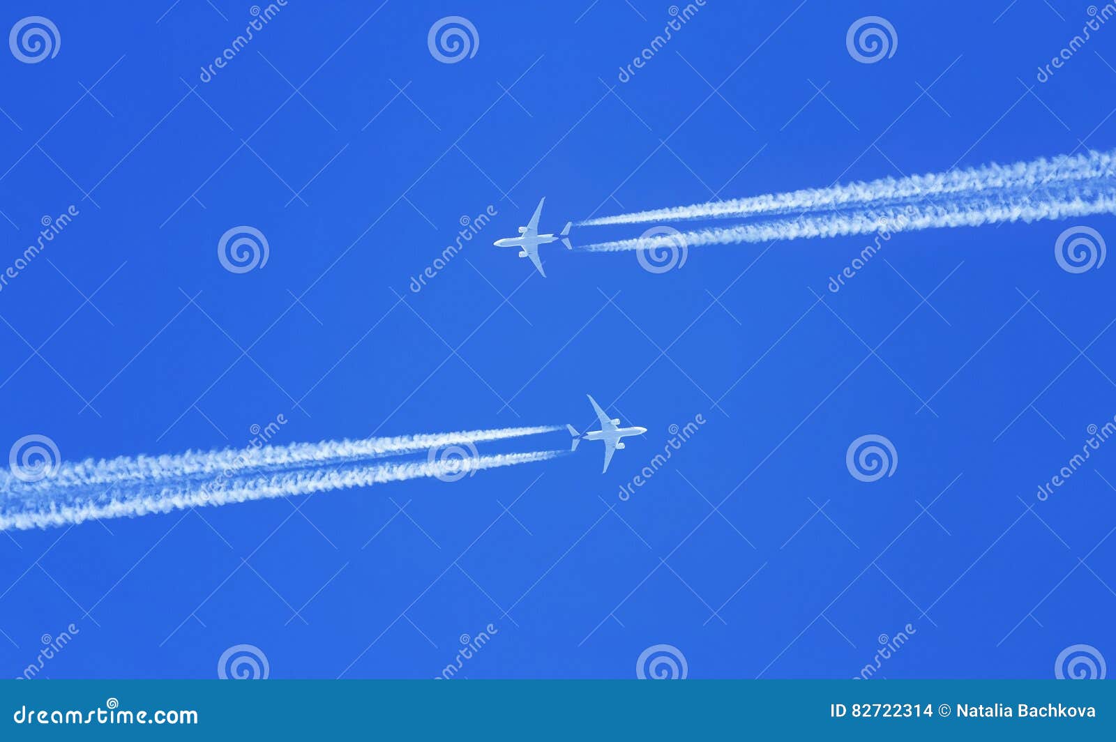 Two Planes Flying High in the Sky Meet, Leaving Streaks Stock Photo ...