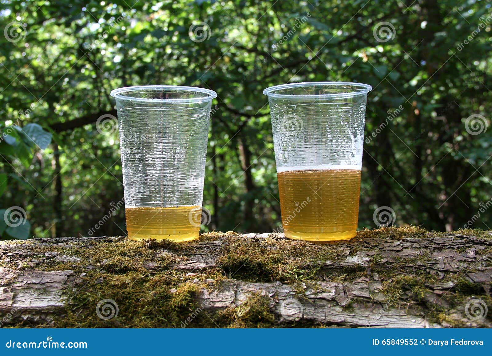 Two plastic cups with beer stock photo. Image of green - 65849552