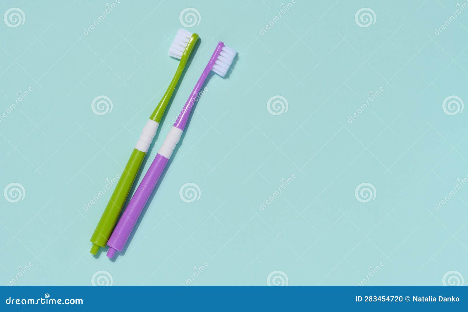 Two Plastic Toothbrushes on a Blue Background, Oral Hygiene Stock Photo ...