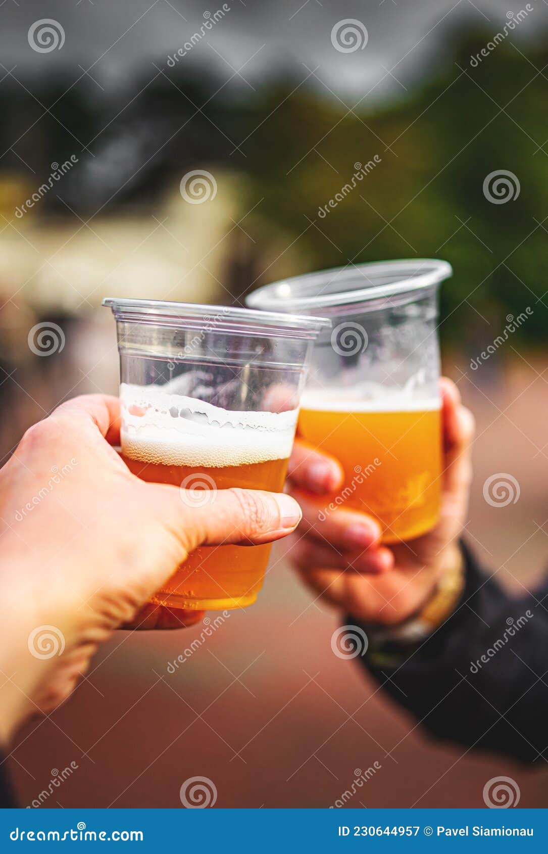 Two Plastick Glass of Beer in Hand. Beer Clinking Stock Image - Image ...