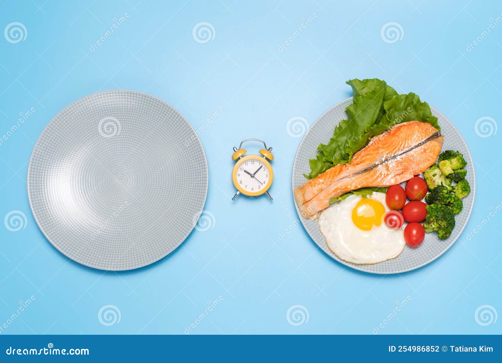 Two Plates Empty and with Food and an Alarm Clock on Blue Background ...