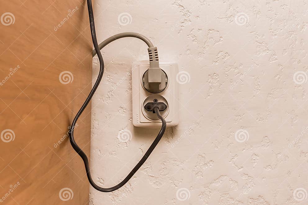 Two Plugs in the Socket in a Modern Interior. Safe Connection of ...