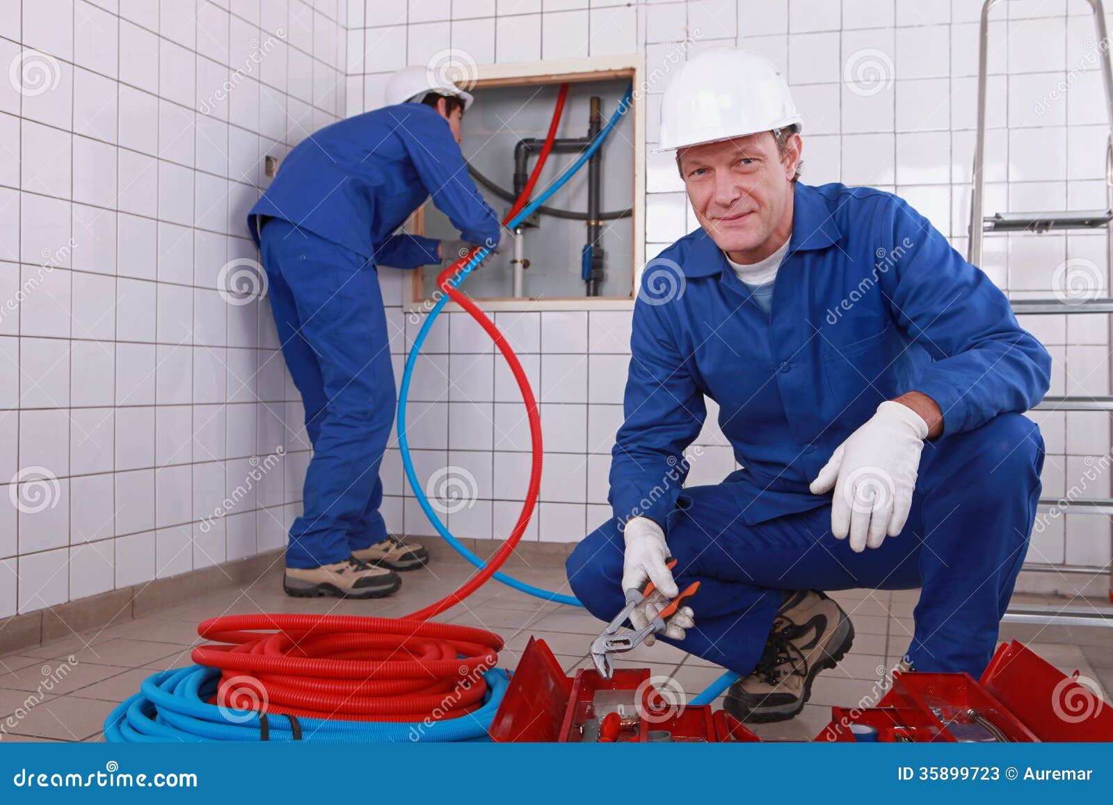 Two plumbers working stock image. Image of jumpsuite - 35899723