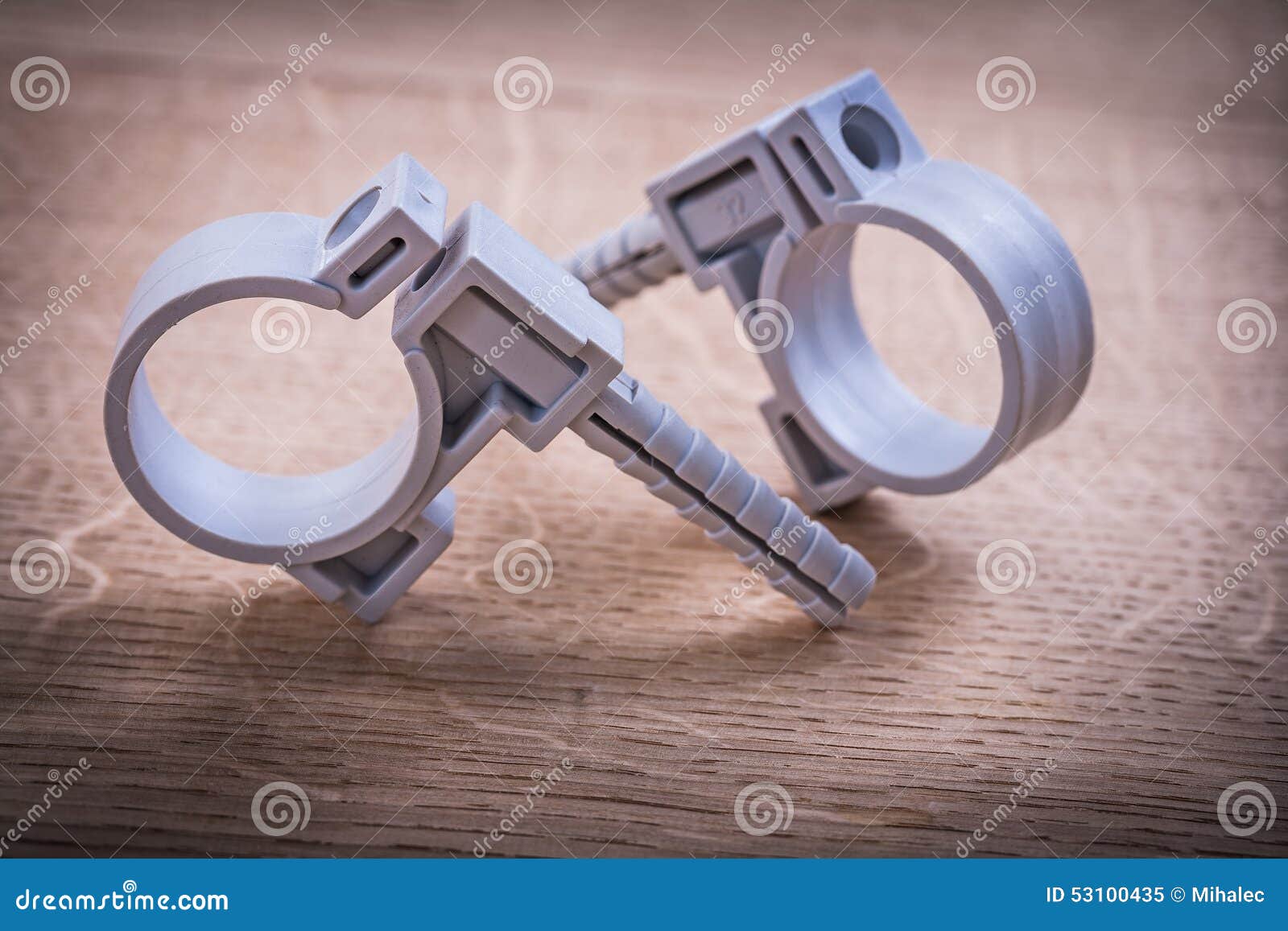 Two Polypropylene Pipe Fixators on Wooden Board Stock Image - Image of ...