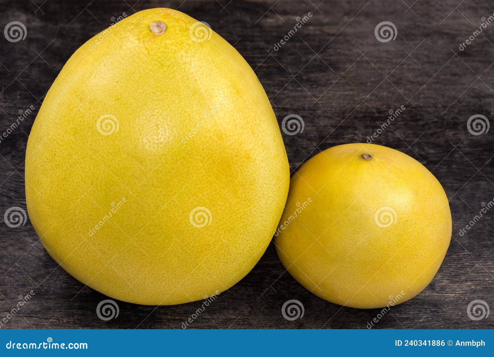 Two Pomelo Fruits Different Sizes on a Black Surface Stock Photo ...