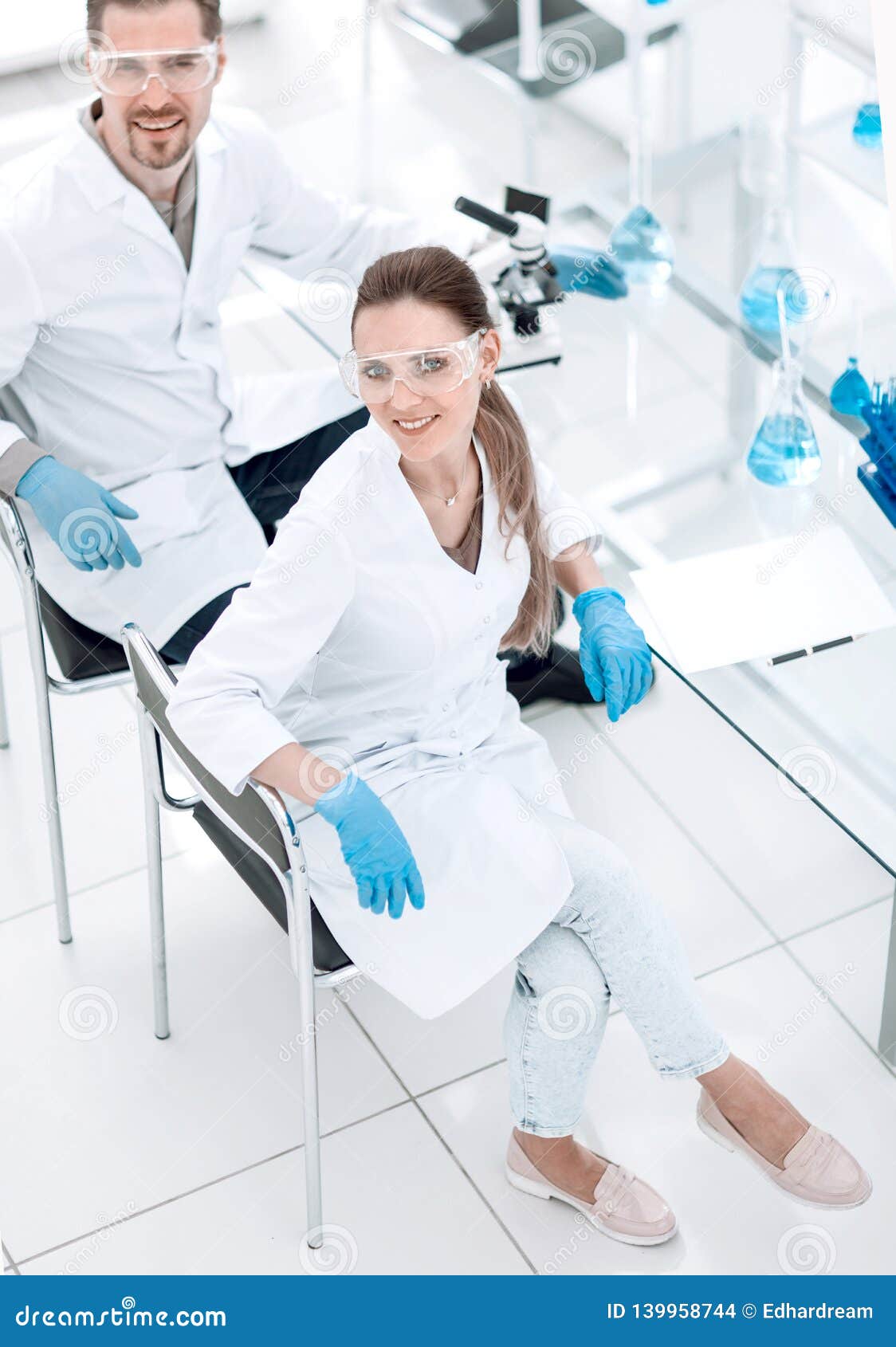 Two Positive Scientists Work Sitting at a Laboratory Table Stock Photo ... Two Positive Scientists Work Sitting at a Laboratory Table Stock Photo ...