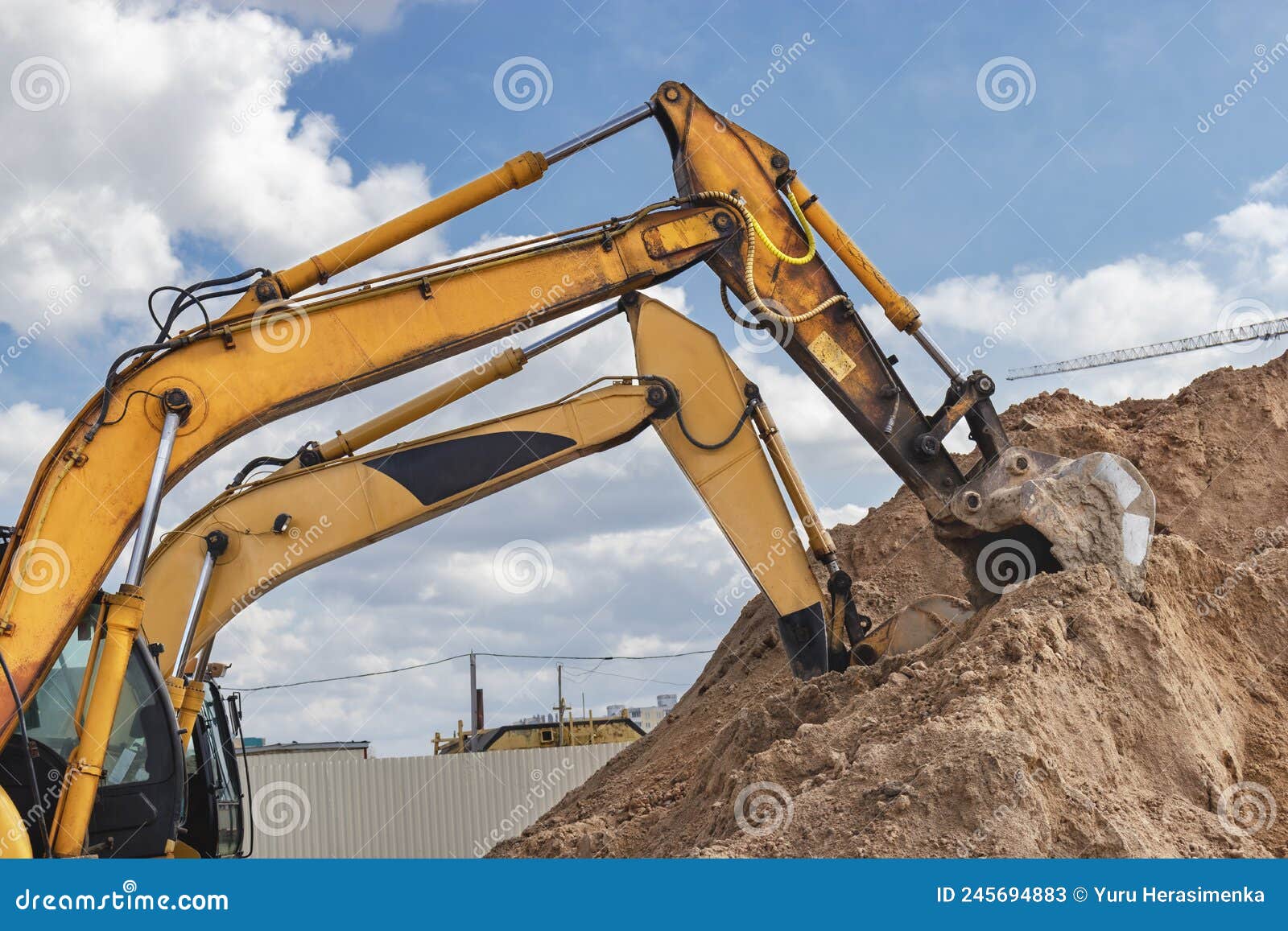 Two Powerful Excavators Work at the Same Time on a Construction Site ...