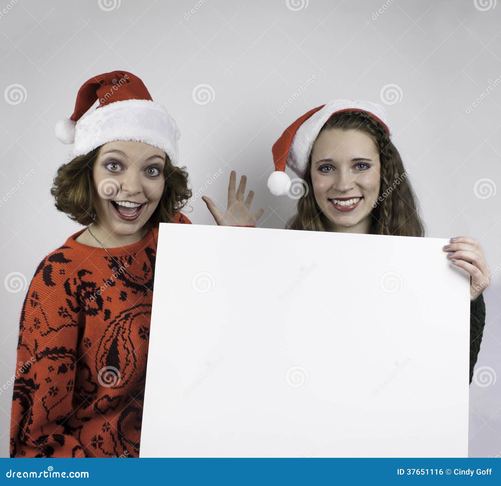 Two Pretty Woman Holding Sign Stock Photo - Image of braid, hats: 37651116