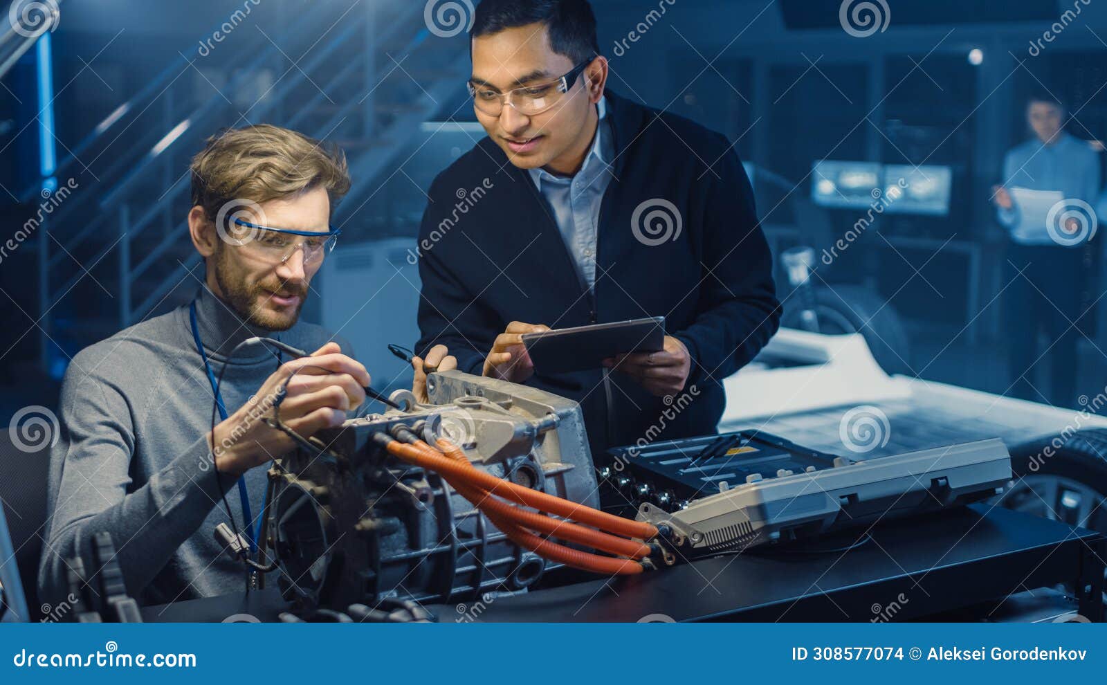 Two Professional Automotive Engineers with a Tablet Computer and ...