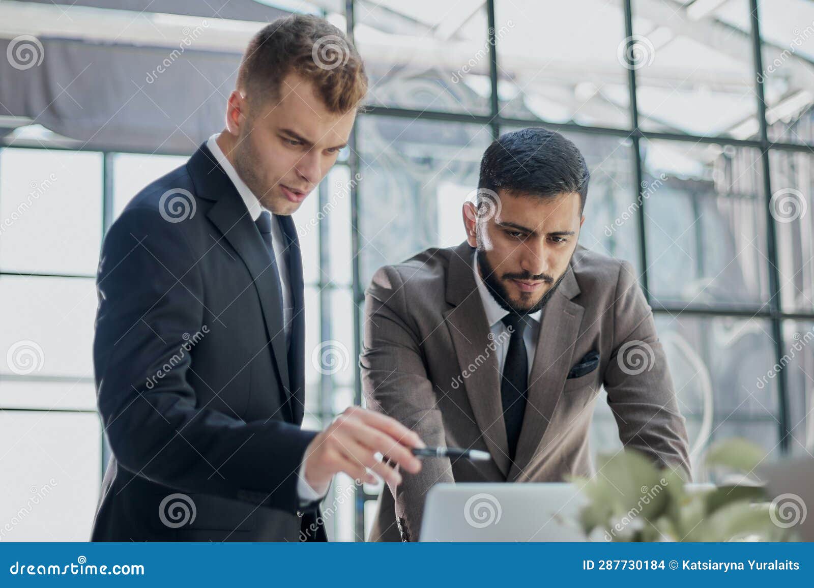 Two Professional Businessmen Discussing and Using Desktop Computer in ...
