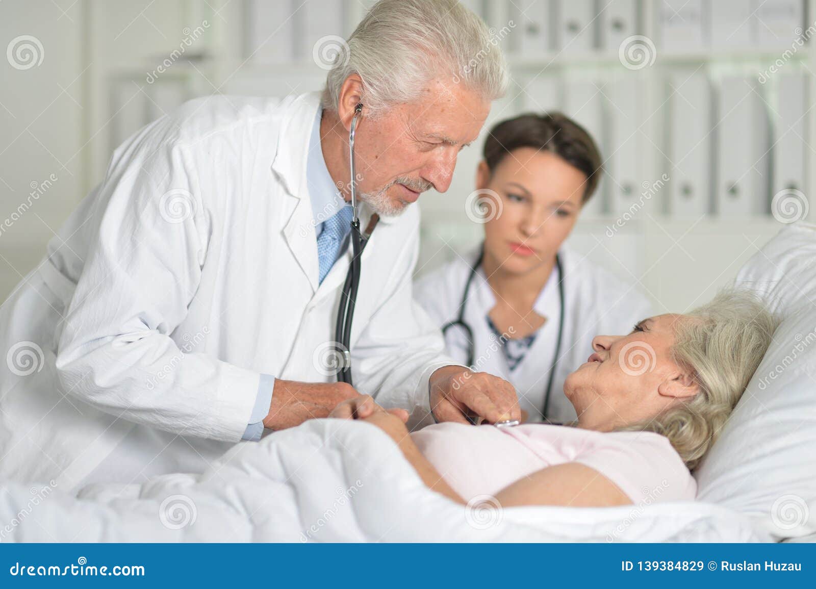 Portrait of Two Professional Doctors Inspecting Patient Stock Image ...