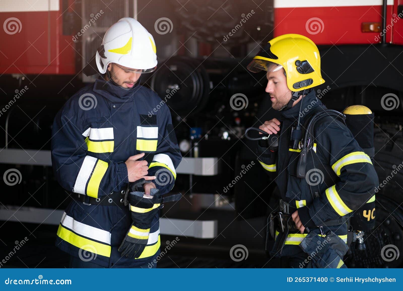 Two Professional Firefighters with Uniforms and Protective Helmets ...