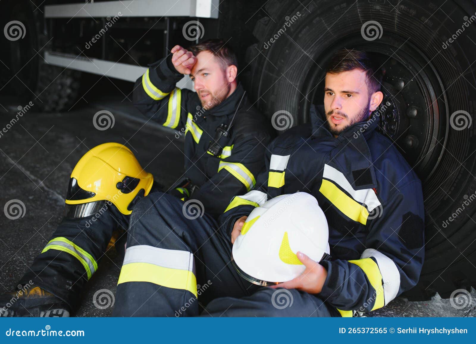 Two Professional Firefighters with Uniforms and Protective Helmets ...