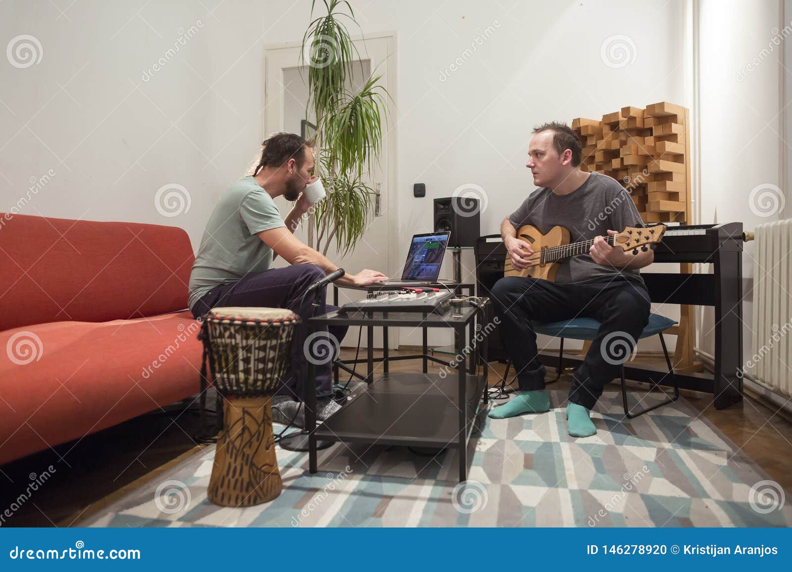 Two Musicians Playing Instruments in Home Music Studio Stock Photo ...