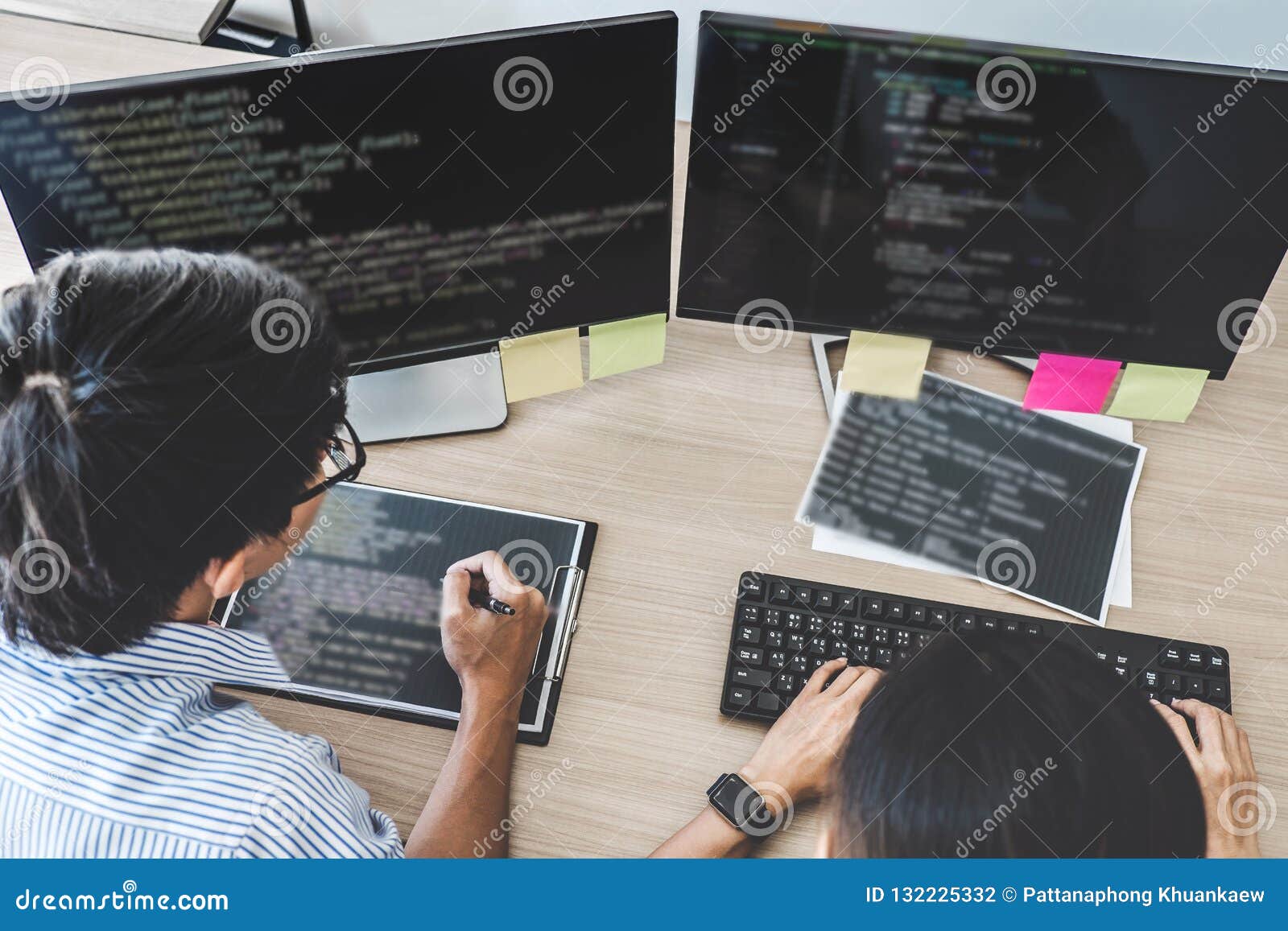 Two Professional Programmers Cooperating At Developing Programming And Website Working In A