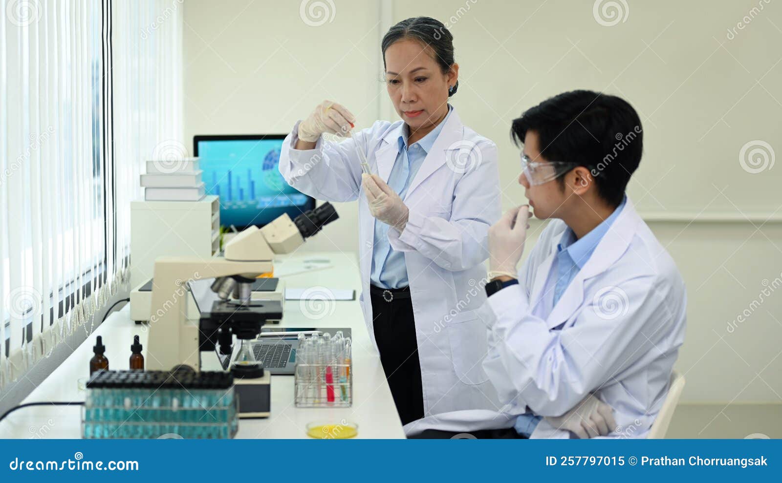 Two Professional Scientist Conducting Experiment with Test Tubes and ...