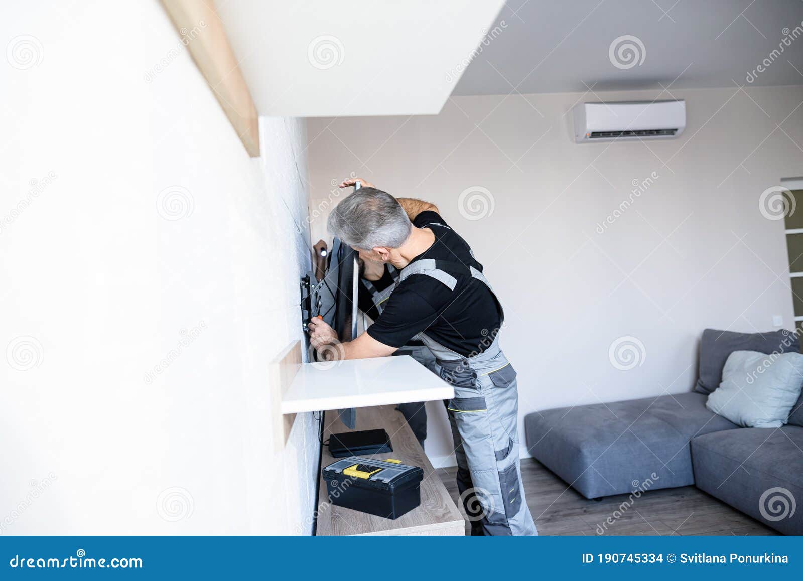 Two Professional Technicians, Workers in Uniform Installing, Fixing ...