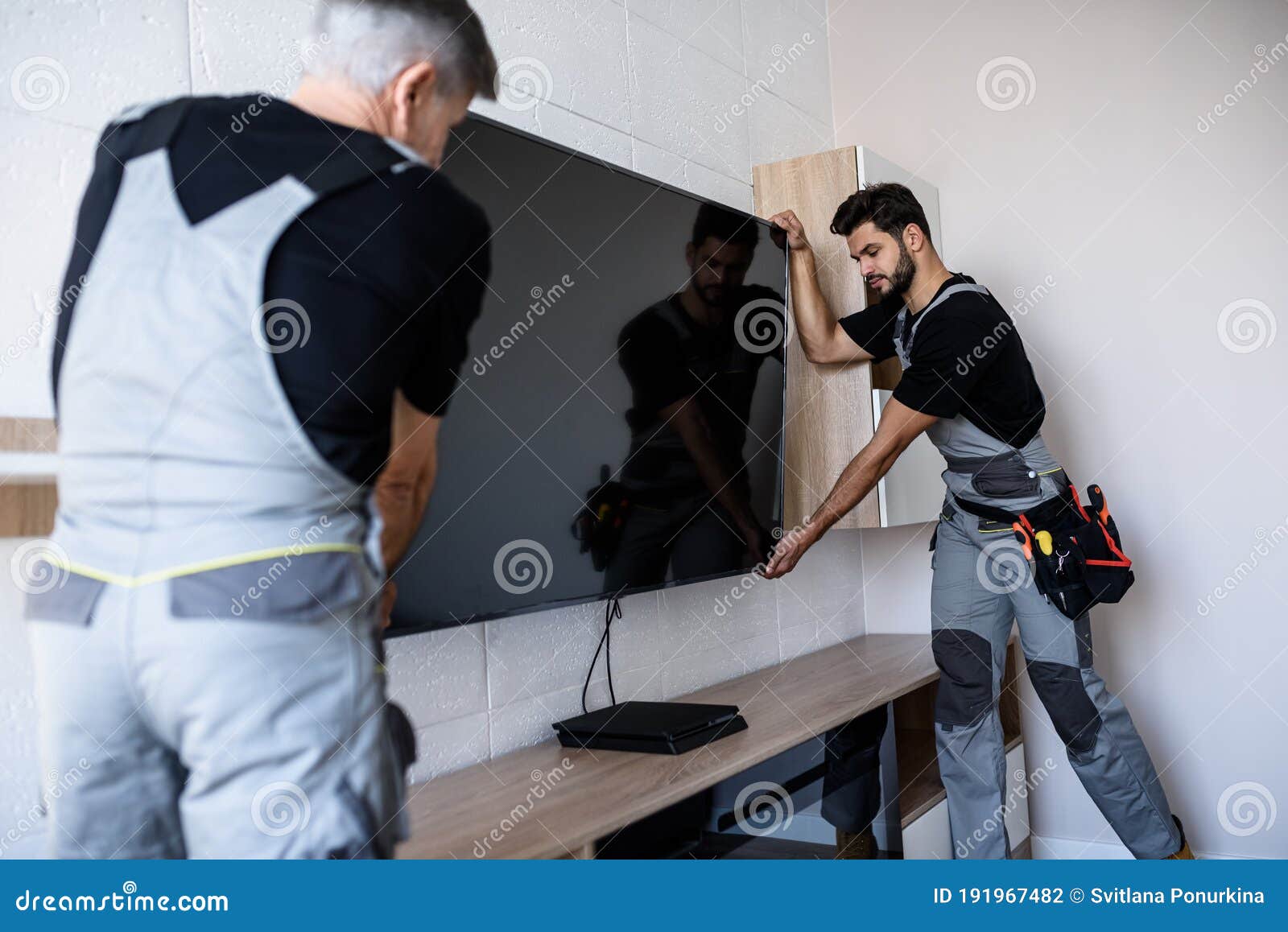 Two Professional Technicians, Workers in Uniform Installing Television ...
