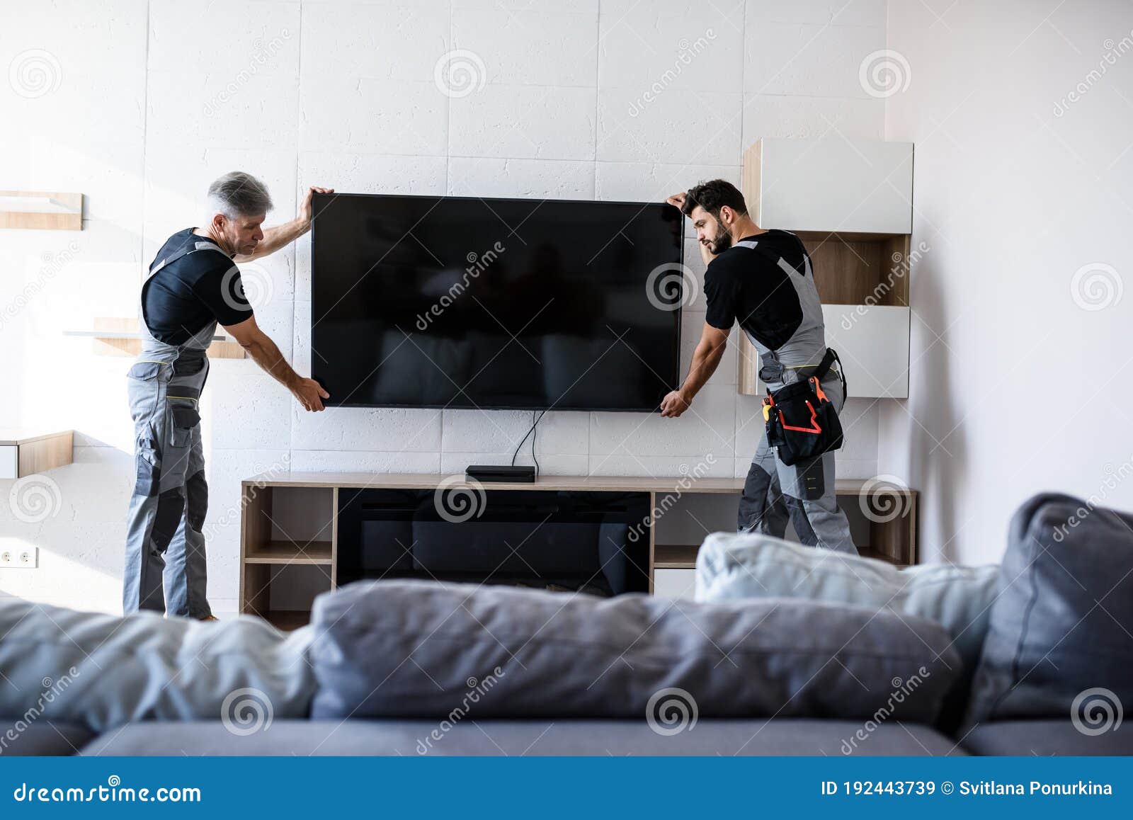 Two Professional Technicians, Workers in Uniform Installing Television ...