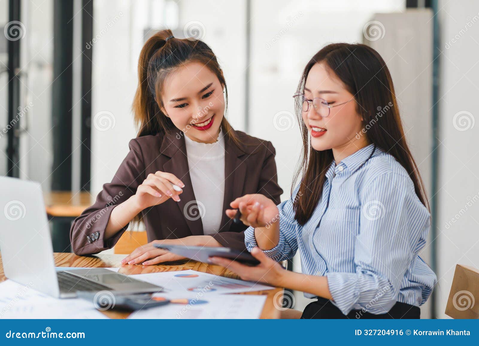 Two Professional Women Collaborating on a Project in Modern Office ...