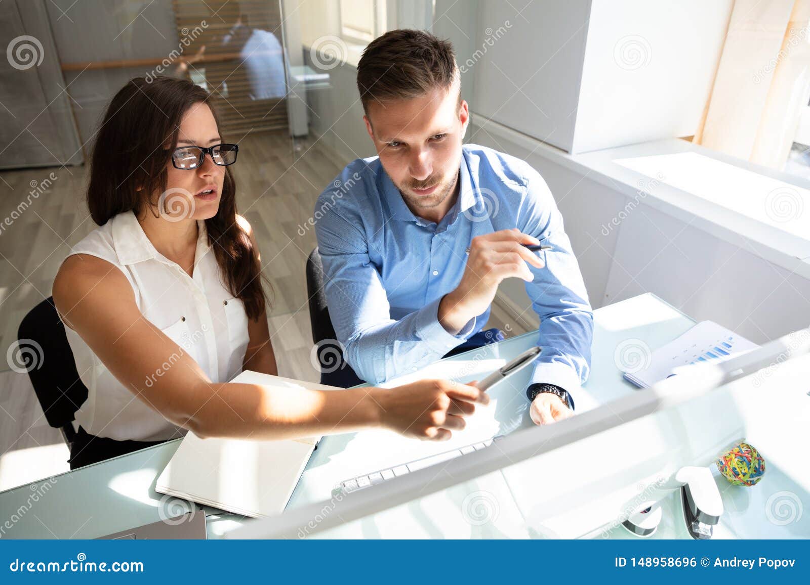 Two Businesspeople Looking at Computer Having Conversation Stock Photo ...