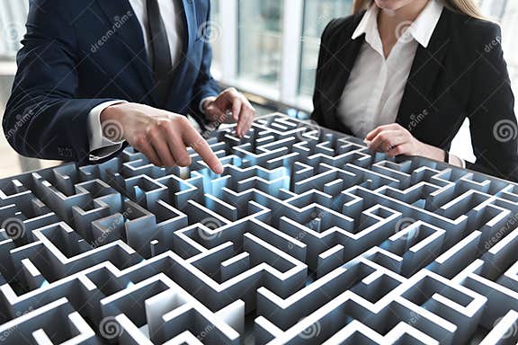 Two Professionals Interact with a 3D Maze, Pointing To Specific Area in ...