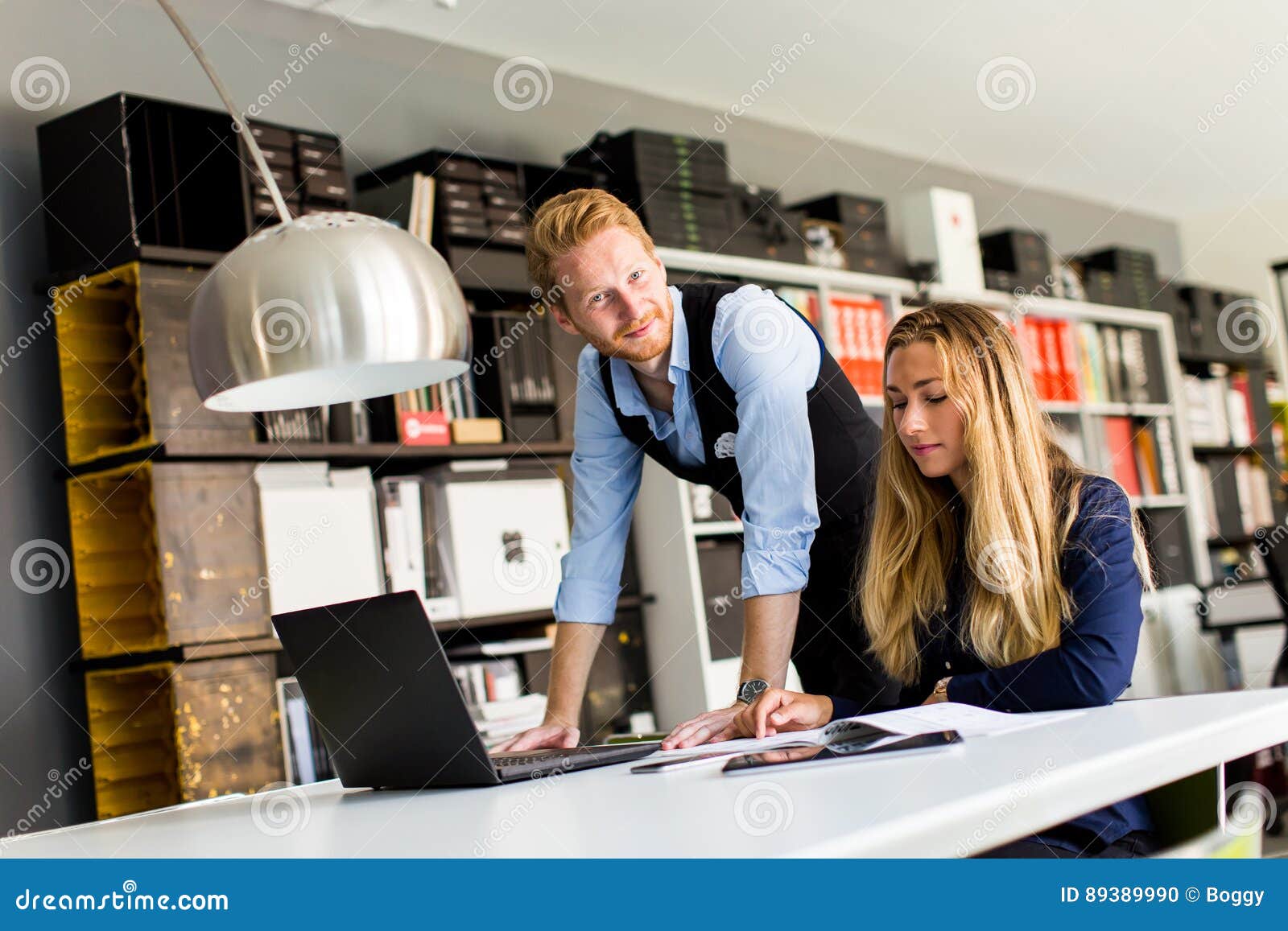 Two Professionals Looking at a Laptop Screen in the Stock Photo - Image ...