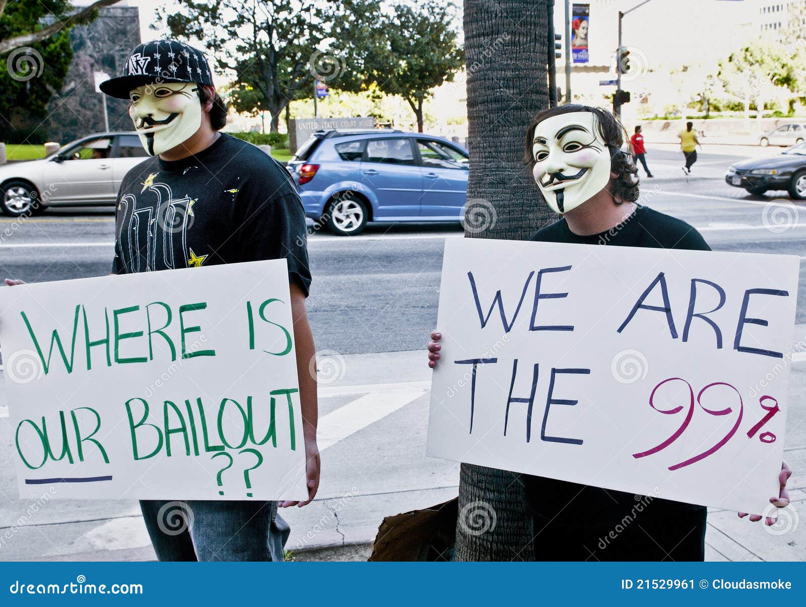 Two Protesters in Masks Hold Signs at Occupy L.a. Editorial Photo ...