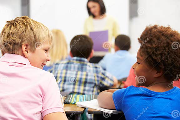 Two Pupils Talking in Class Together Stock Photo - Image of american ...