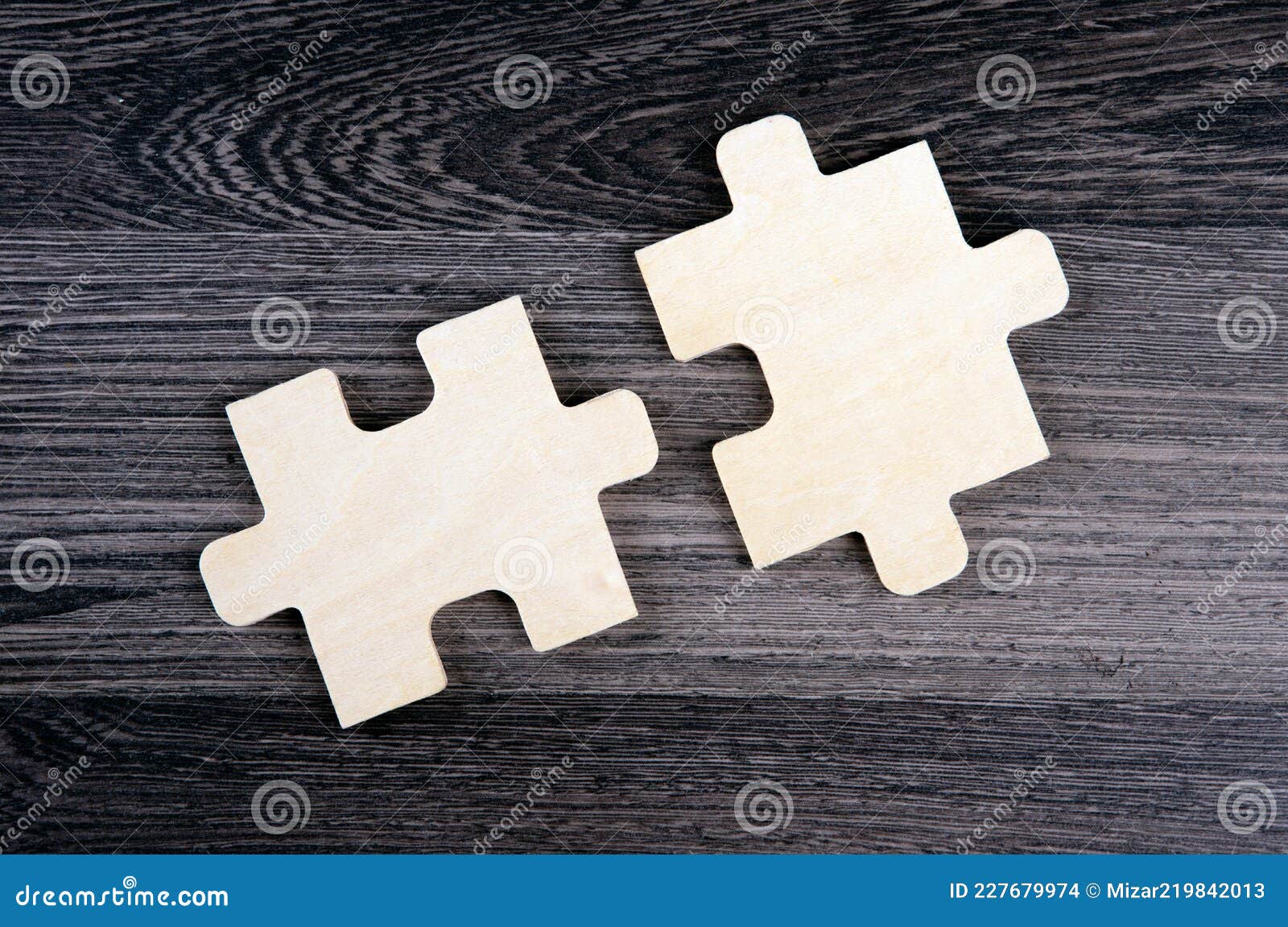 Two Puzzle Pieces in a Row on a Wooden Background Stock Photo - Image ...