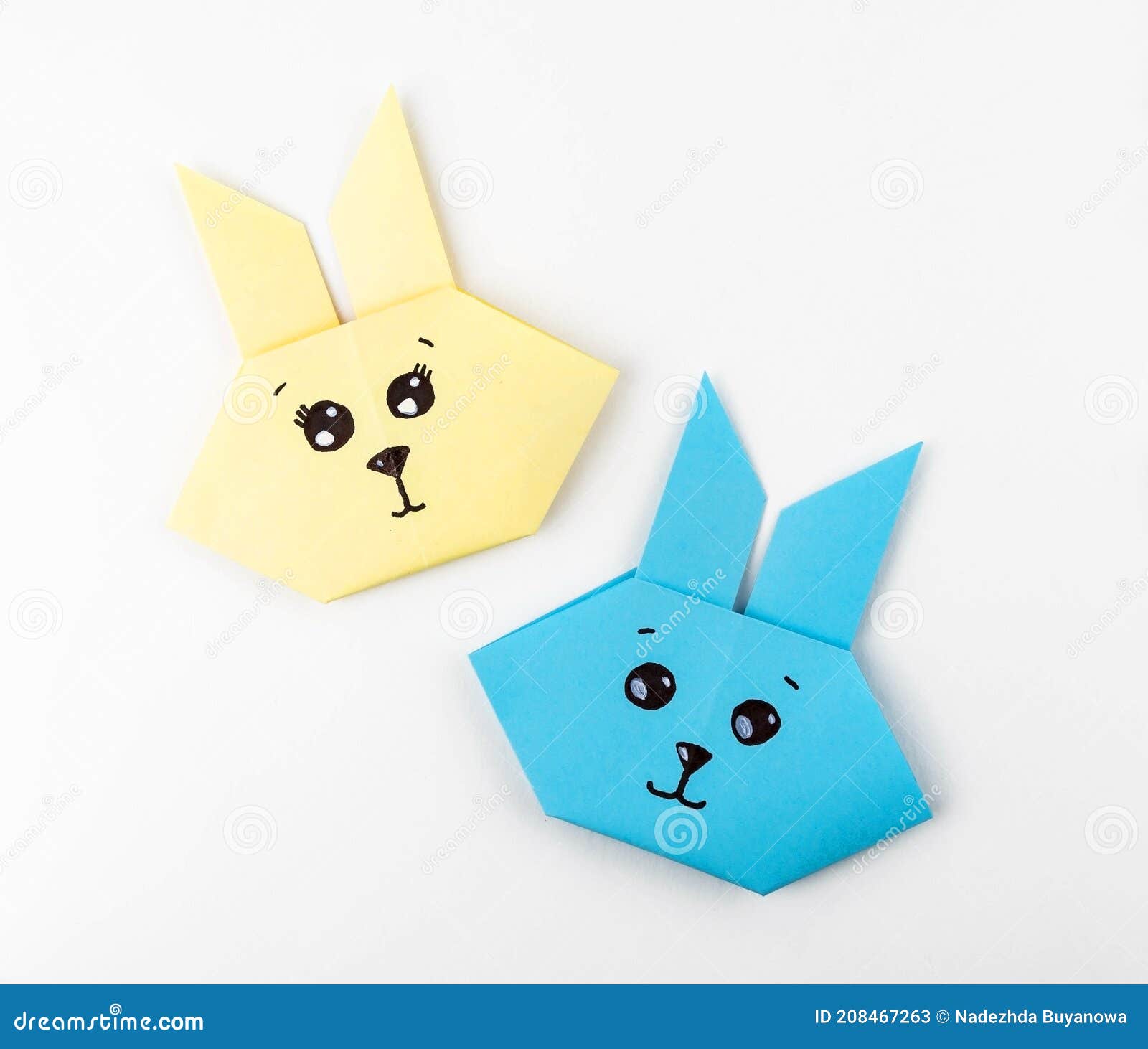 Two Rabbits Made of Paper Origami Yellow and Blue on a White Background ...