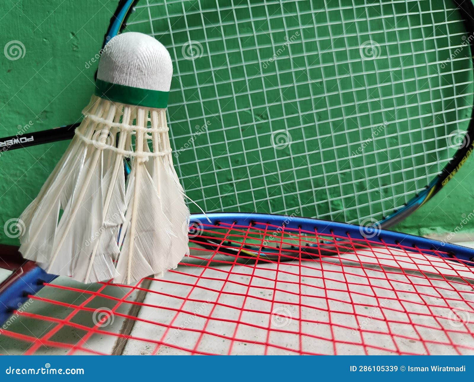 Two Rackets Lying on the Floor with One Shuttlecock on it Stock Image ...