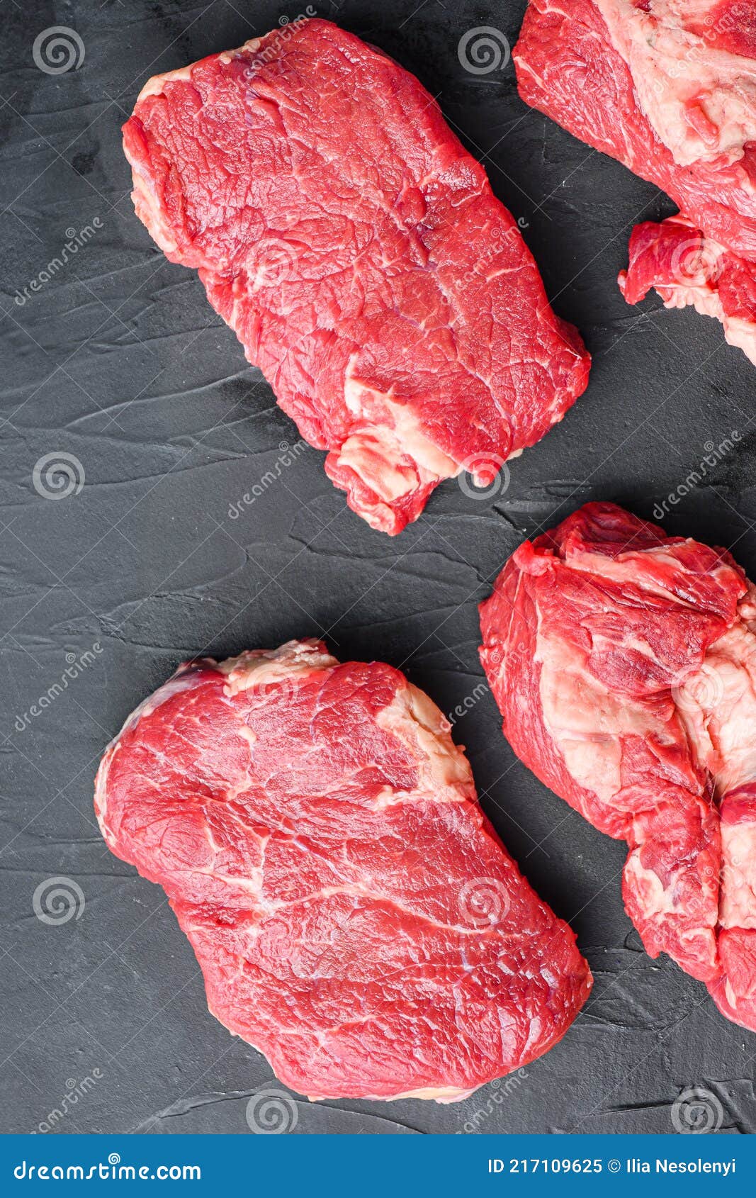 Two Raw Organic Rump Beef Steaks, Side View on Black Textured Table ...