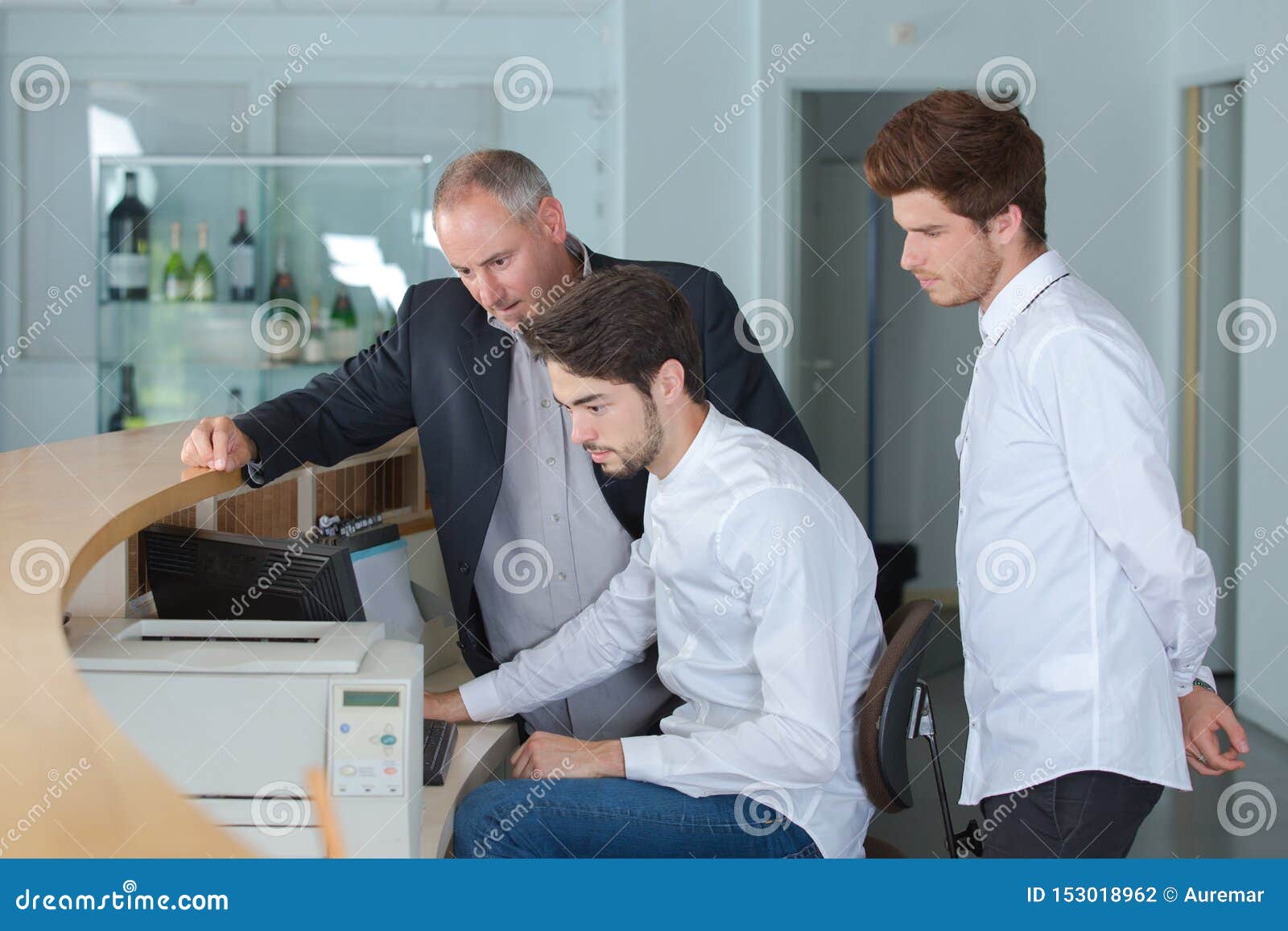 Two Receptionist Workers and Manager Standing at Hotel Counter Stock ...