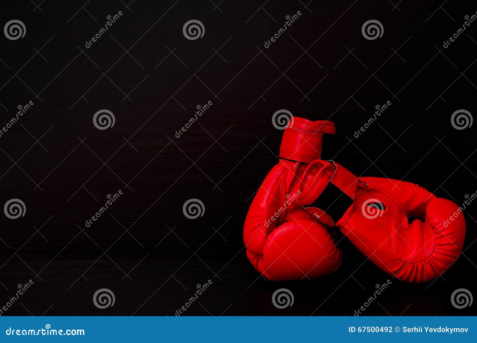 Two Red Boxing Gloves on the Side of the Frame on a Black Background ...