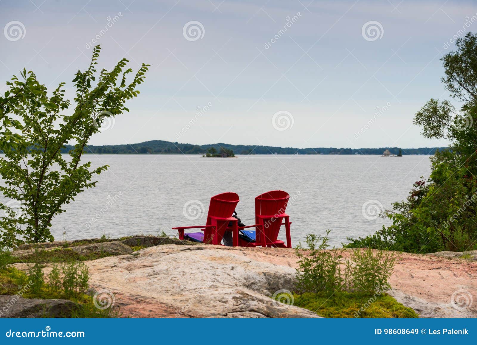 Two red chairs on a rock stock image. Image of travel - 98608649