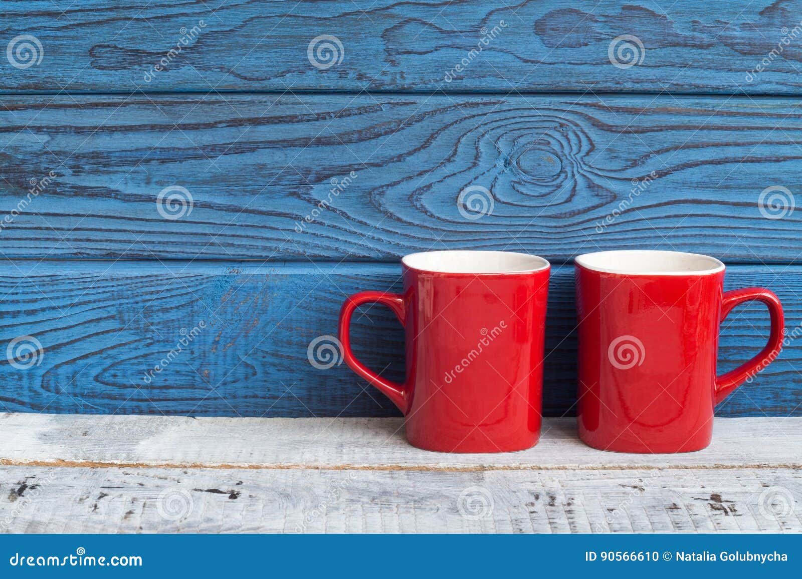 Two Red Coffee Cups on a Background of Blue Boards Stock Photo - Image ...