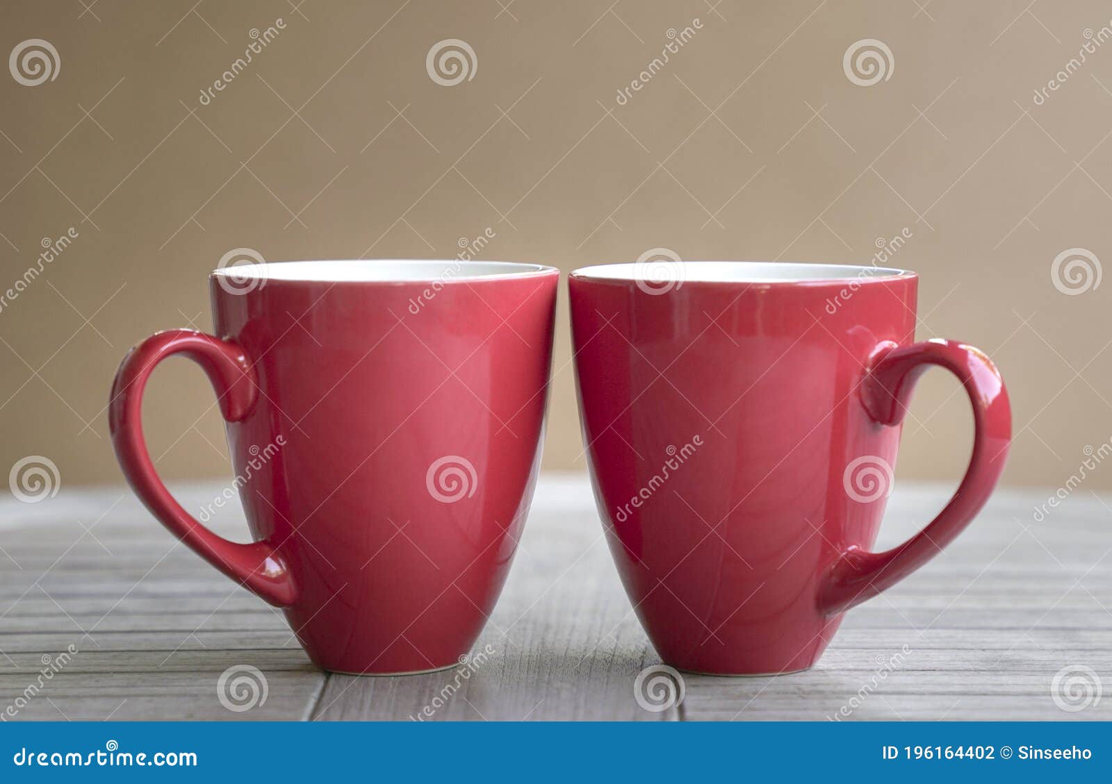 Two red cups on table stock photo. Image of twin, wood - 196164402