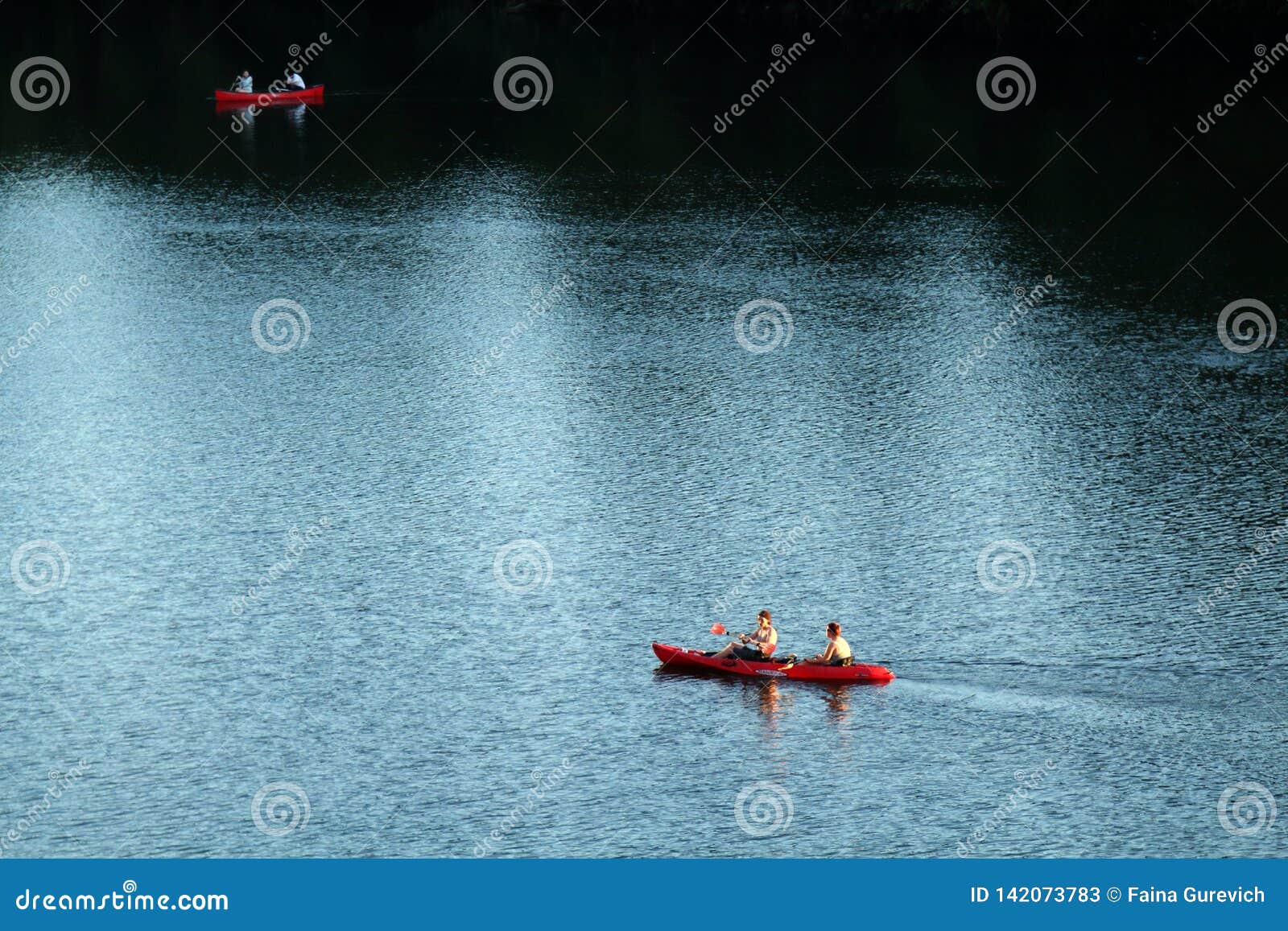 Two Red Kayaks Navigating Light And Dark Waters Of Colorado River As