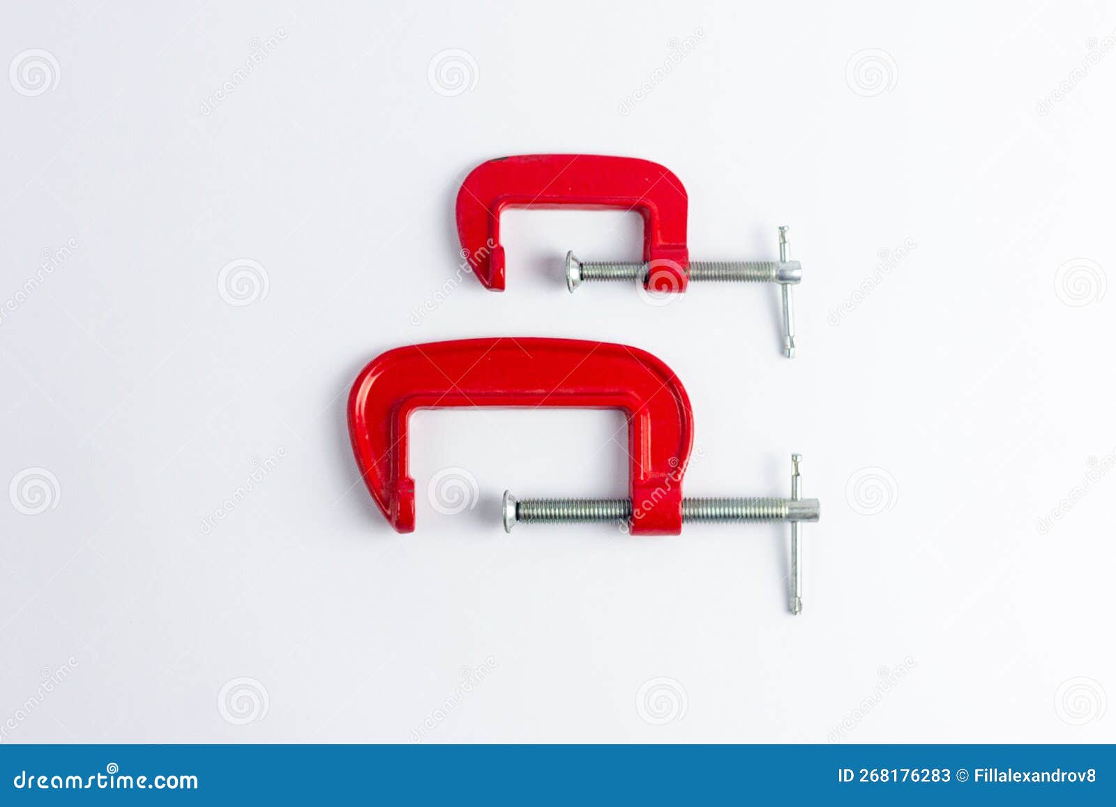 Two Red Metal Clamps of Different Sizes on a White Background. Tools ...