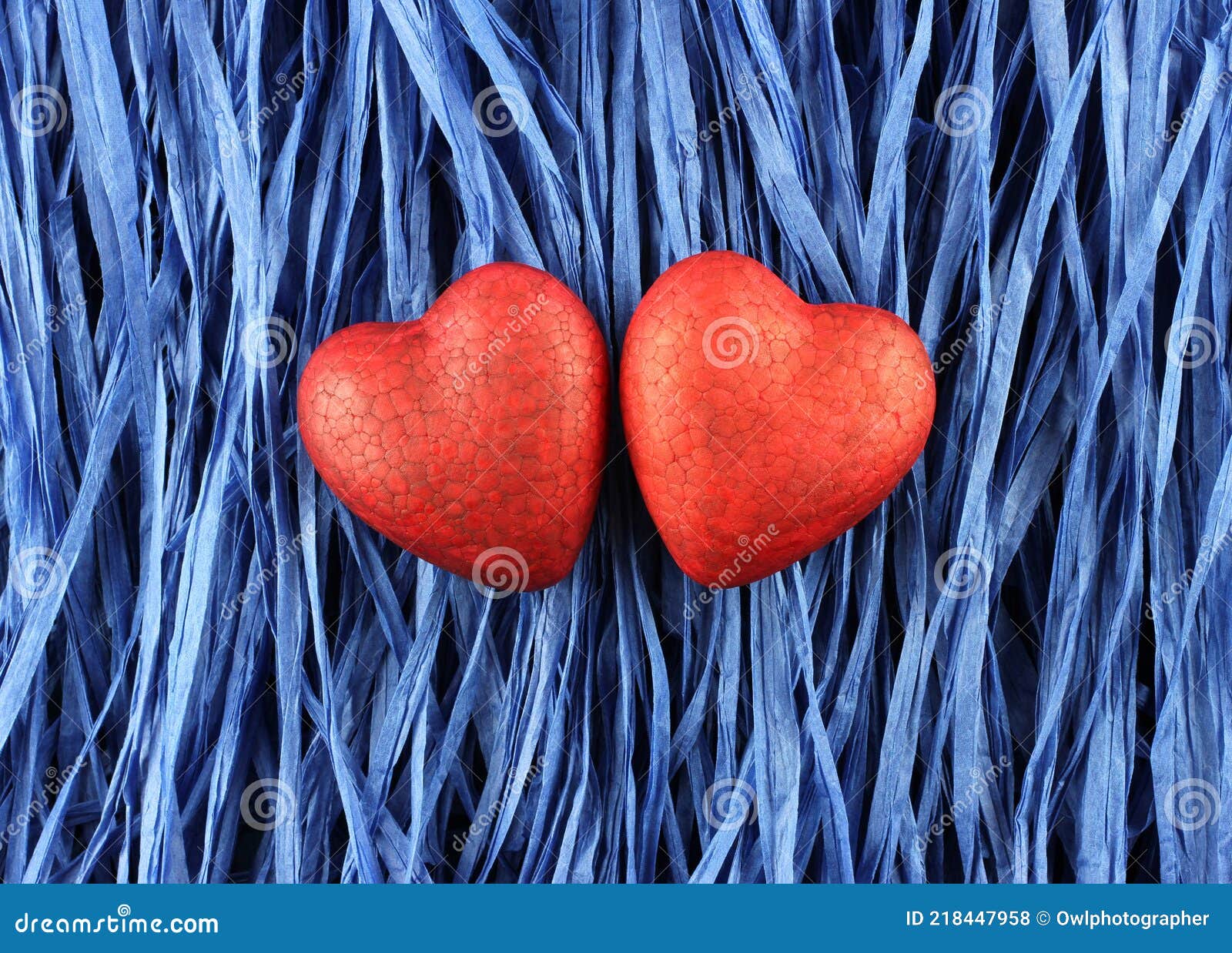 Two Red Painted Polyfoam Hearts on Blue Paper Raffia Background ...
