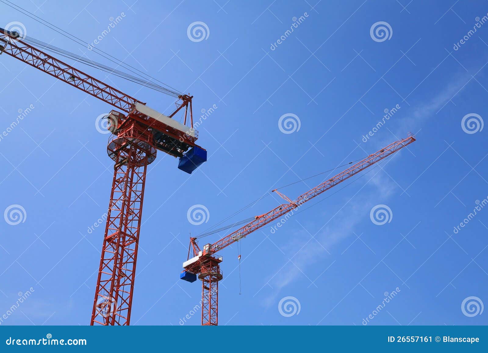 Two red tower cranes stock image. Image of equipment - 26557161