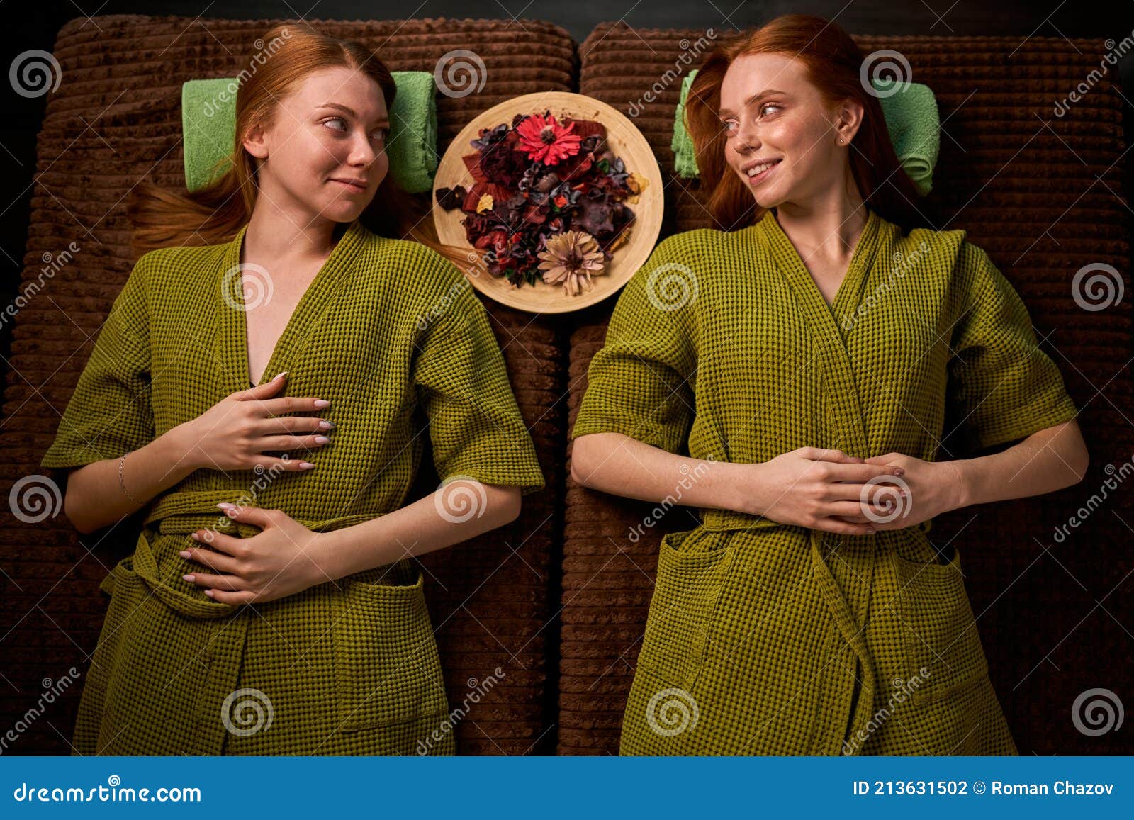 Two Redhead Ladies Lie On Bed Relaxing After Spa Treatment Massage