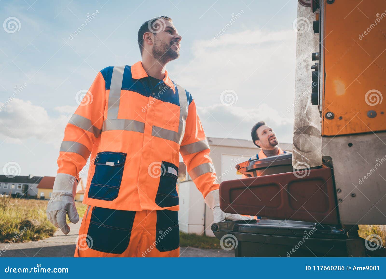 Two Refuse Collection Workers Loading Garbage into Waste Truck Stock ...