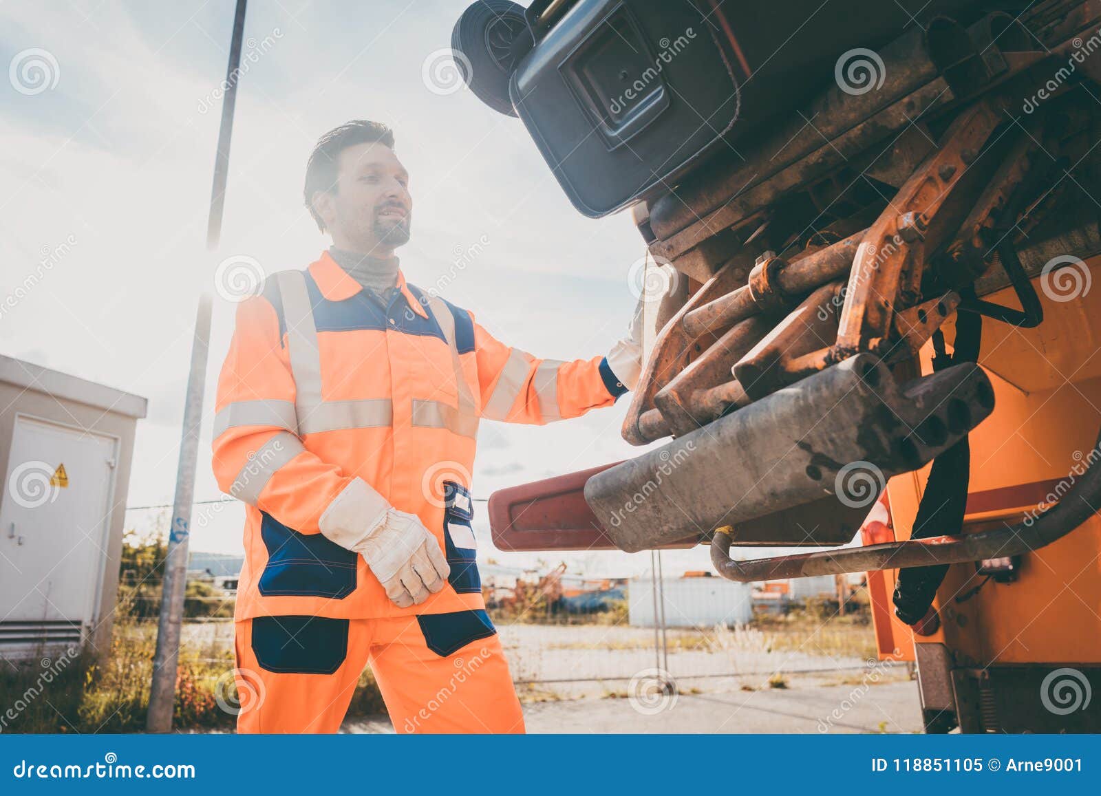 Two Refuse Collection Workers Loading Garbage into Waste Truck Stock ...