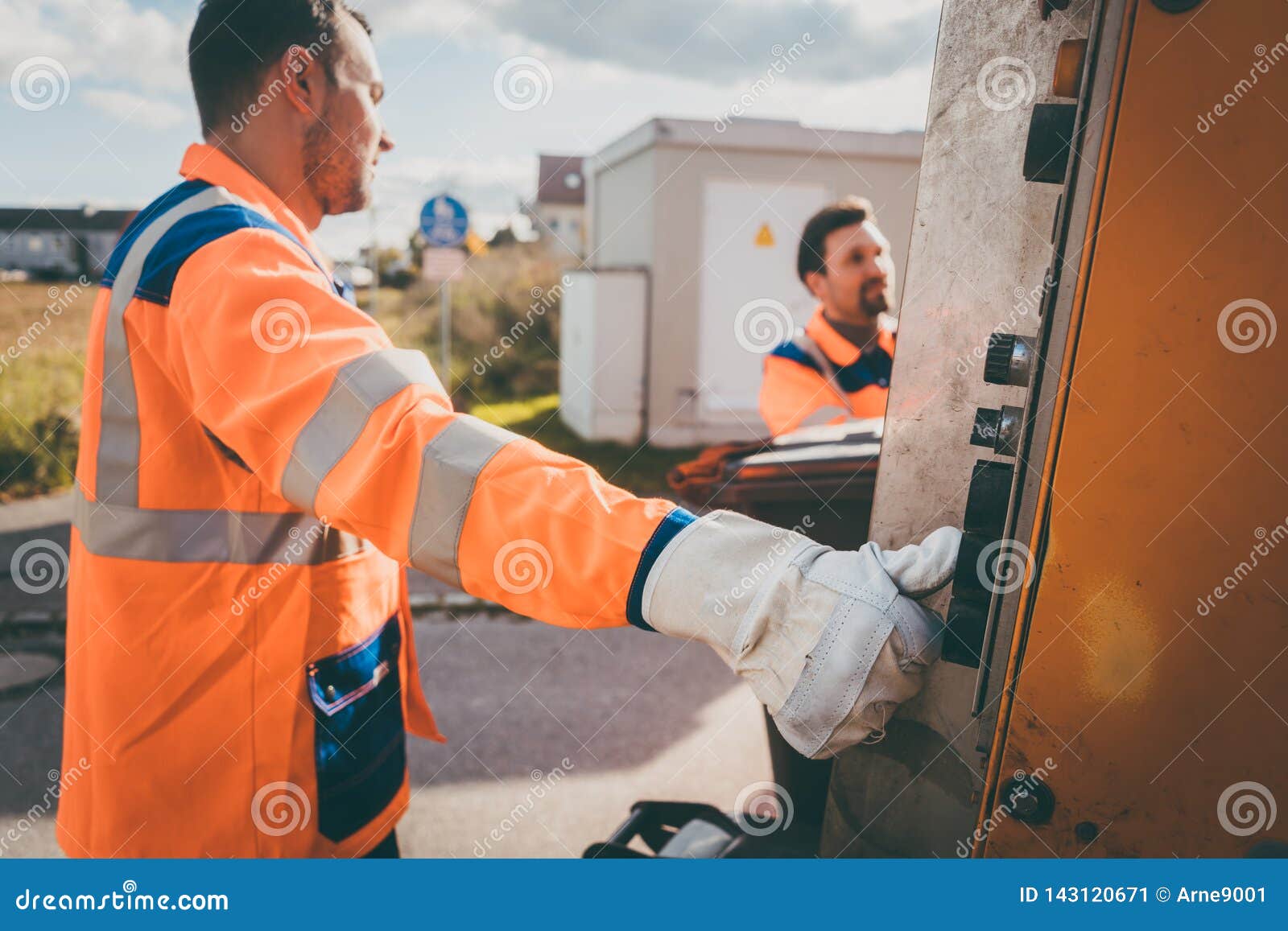 Two Refuse Collection Workers Loading Garbage Into Waste Truck Royalty ...