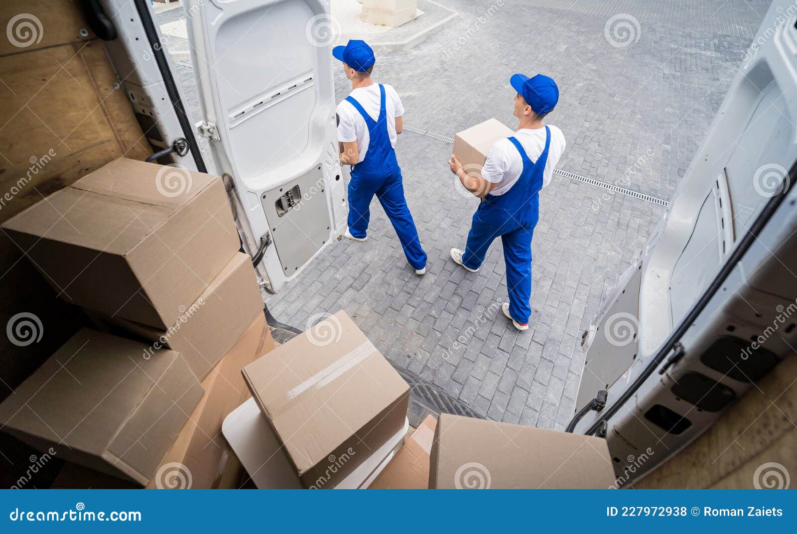 Two Removal Company Workers Unloading Boxes from Minibus Stock Photo ...