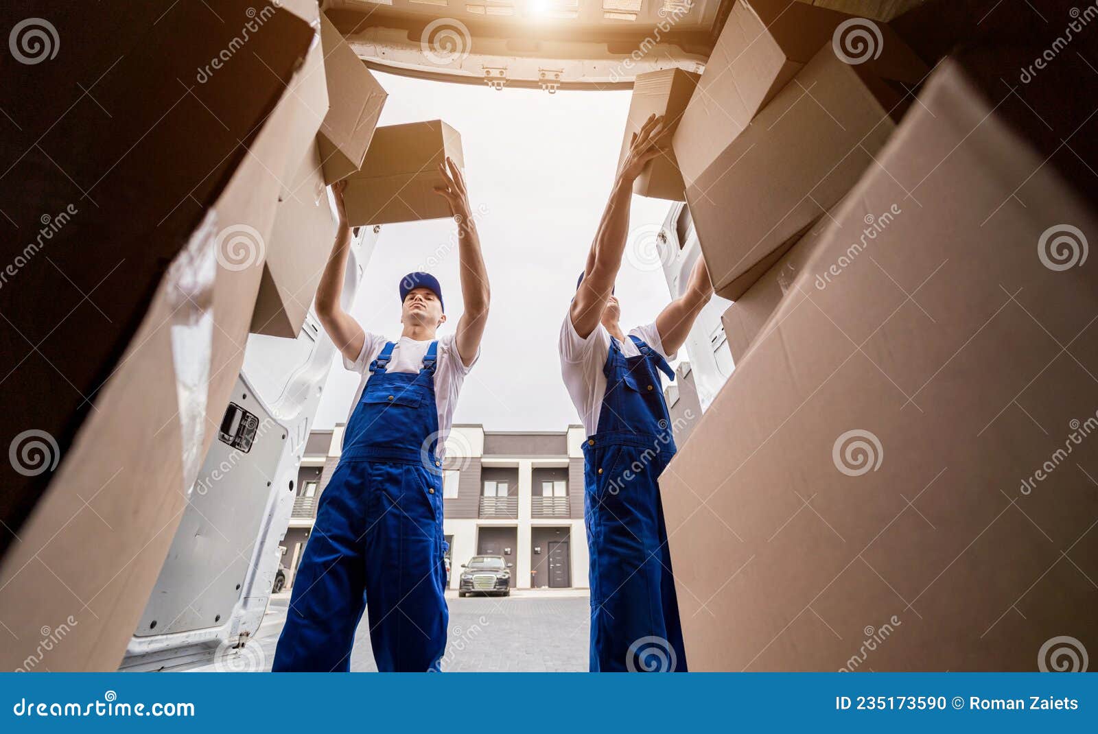 Two Removal Company Workers Unloading Boxes from Minibus Stock Photo ...