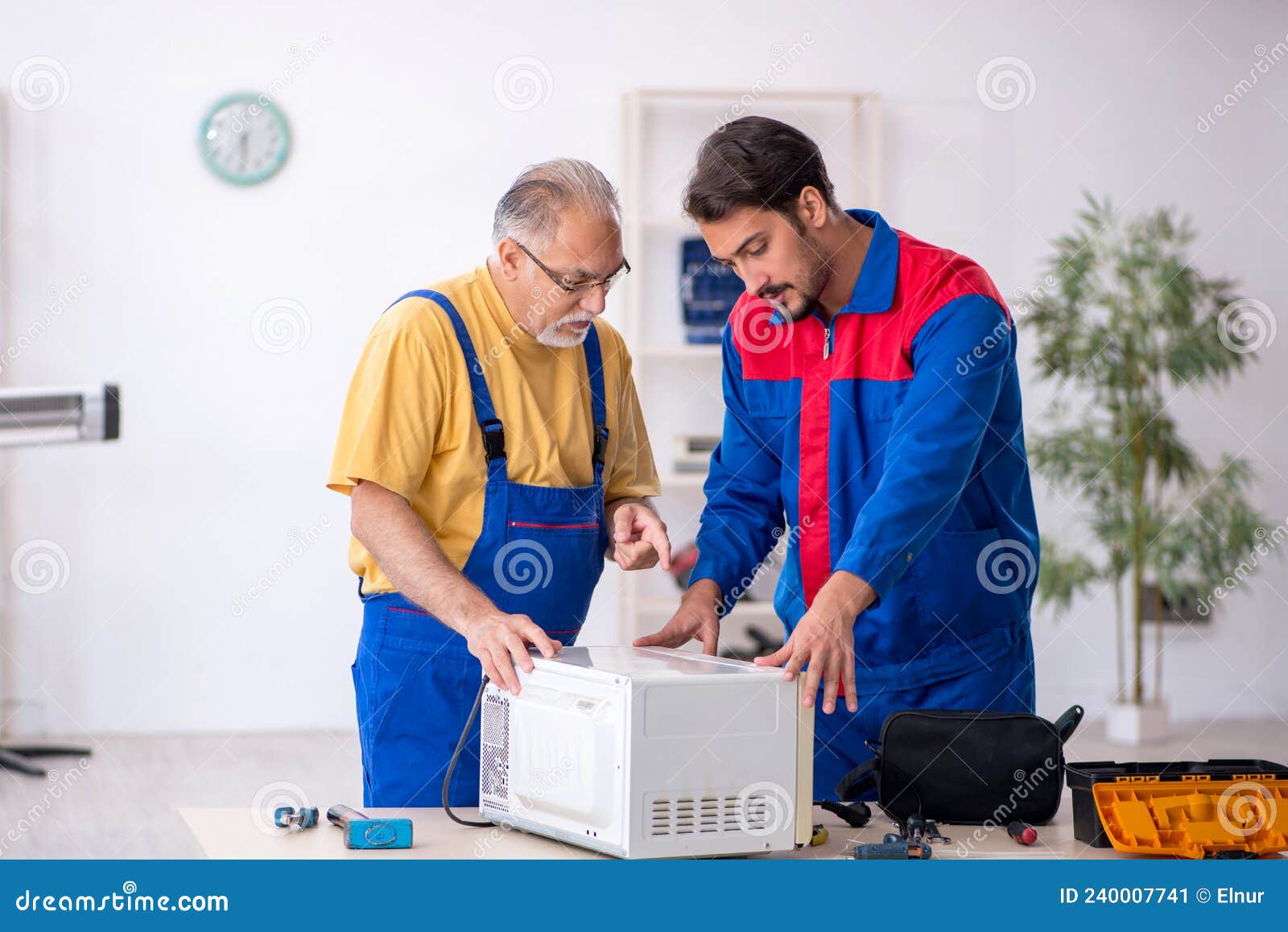 Two Male Repairmen Working at Workshop Stock Image - Image of teamwork ...